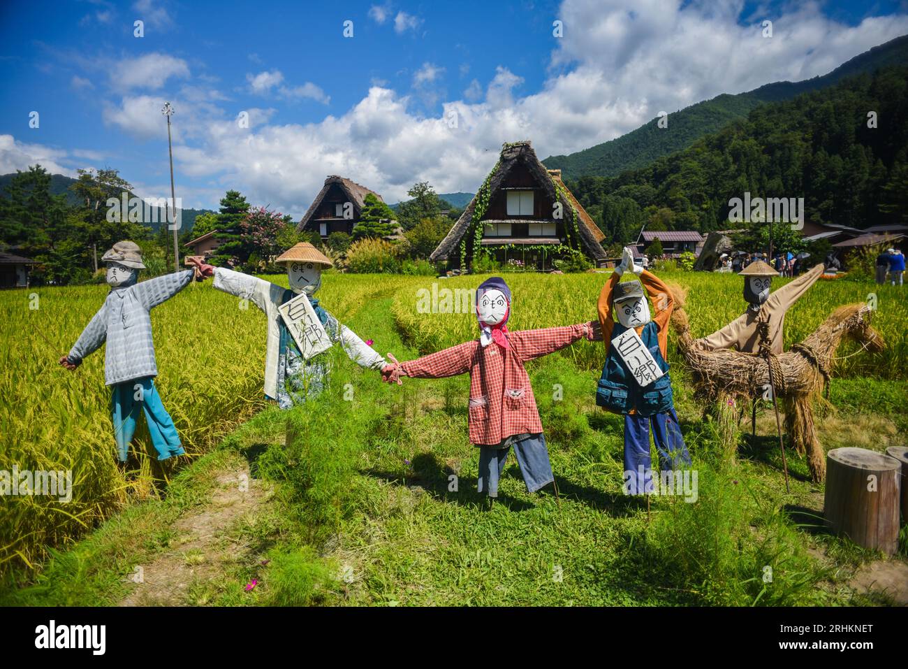 Scarecrows in front of traditional Gassho-Zukuri thatched wooden ...