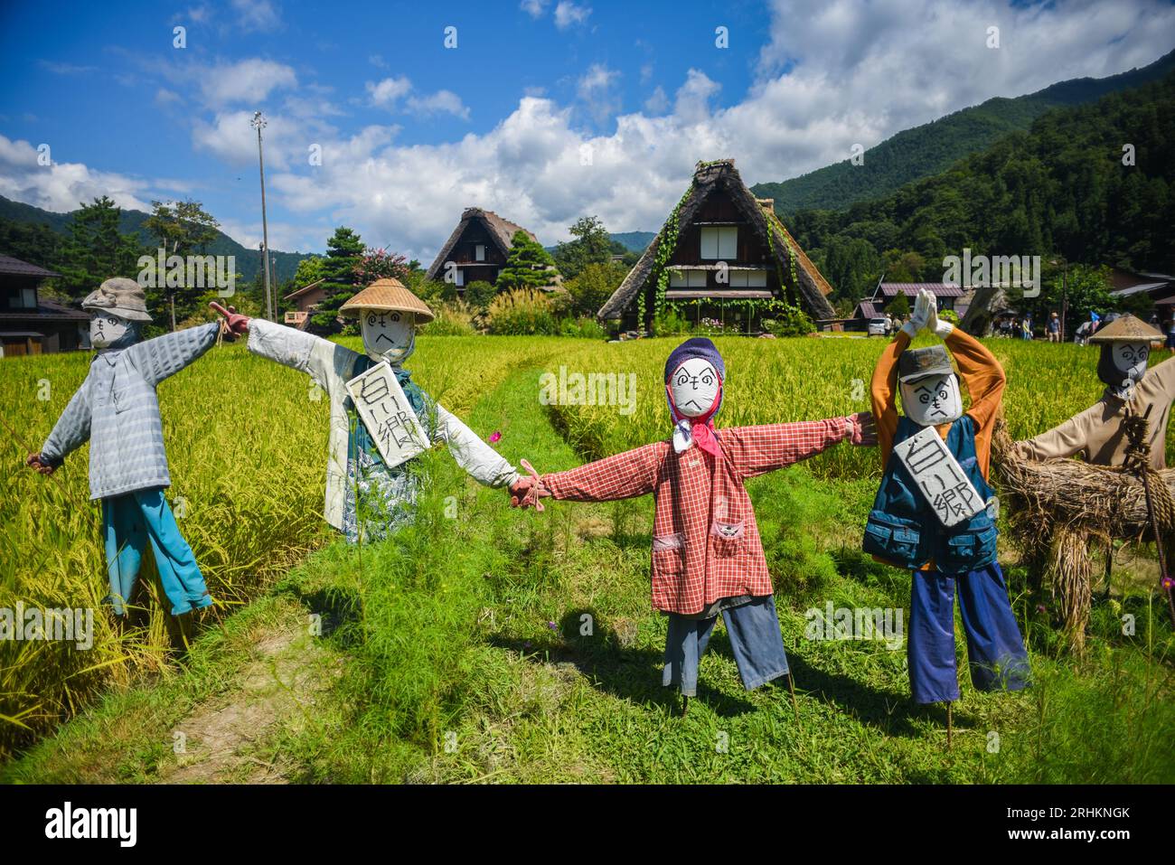 Scarecrows in front of traditional Gassho-Zukuri thatched wooden ...