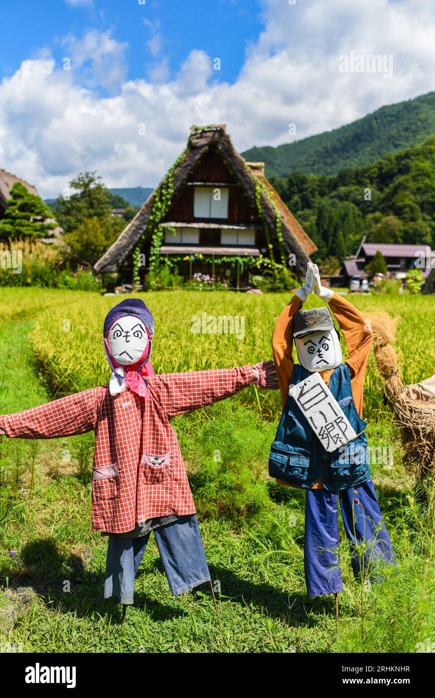 Scarecrows in front of traditional Gassho-Zukuri thatched wooden ...