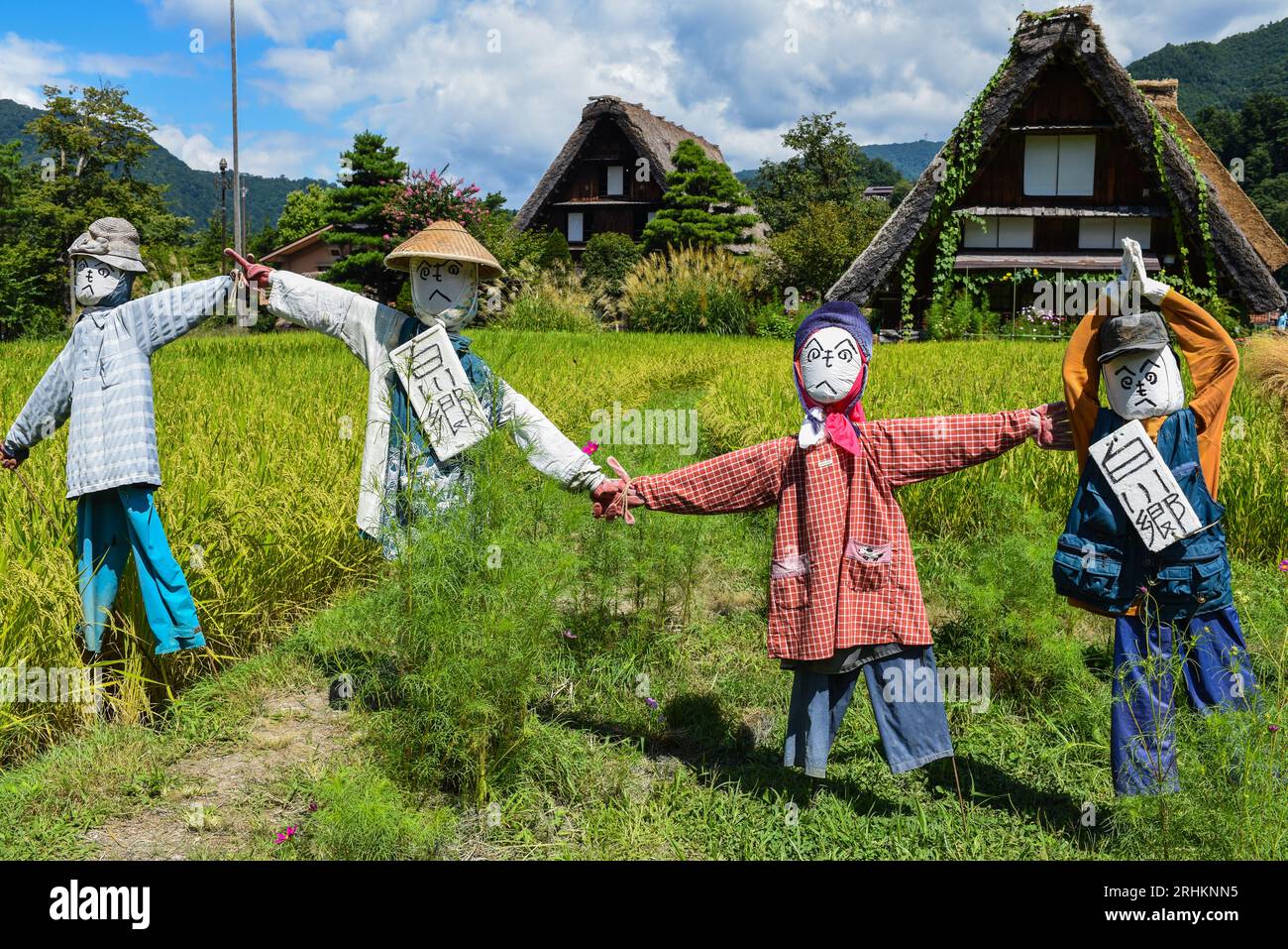 Scarecrows in front of traditional Gassho-Zukuri thatched wooden ...