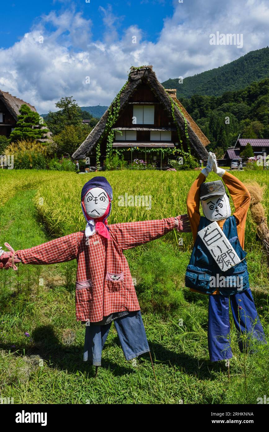 Scarecrows in front of traditional Gassho-Zukuri thatched wooden ...