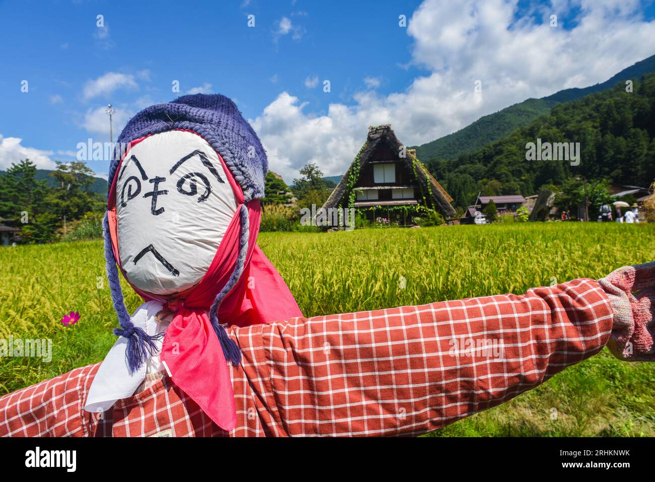 Scarecrows in front of traditional Gassho-Zukuri thatched wooden ...