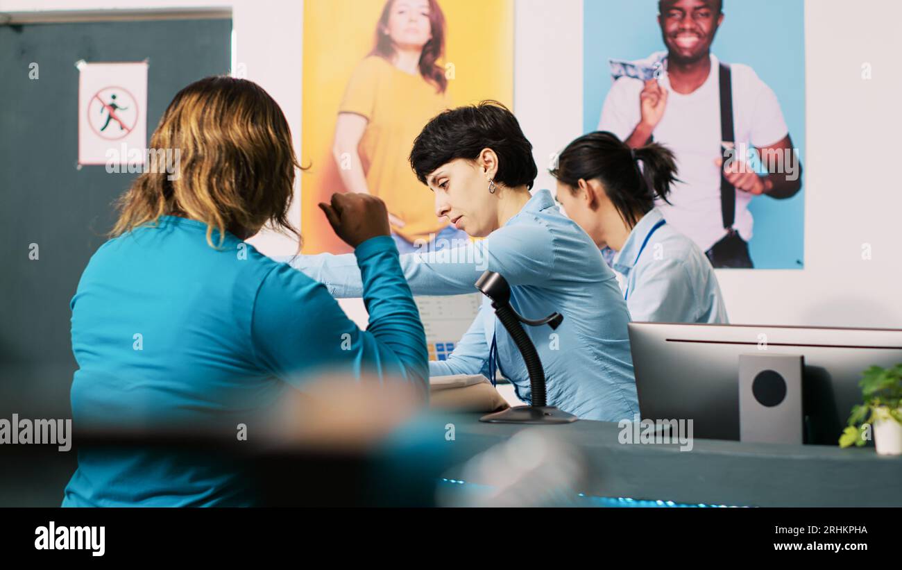 Caucasian manager scanning customer clothes using store scanner in ...