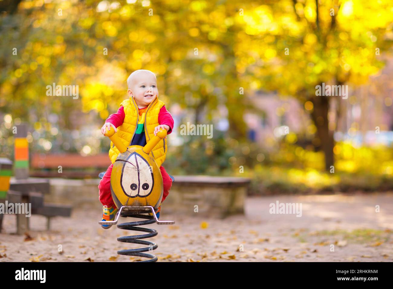 Kids on playground Children play in autumn park. Child on slide and ...