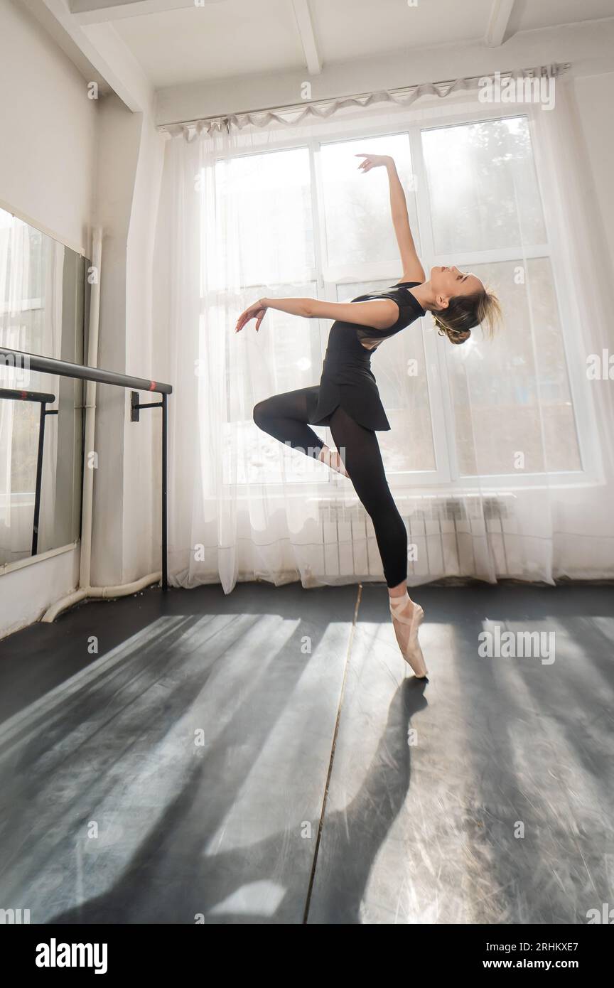A beautiful Asian woman is dancing at the barre. Ballet dancer Stock ...