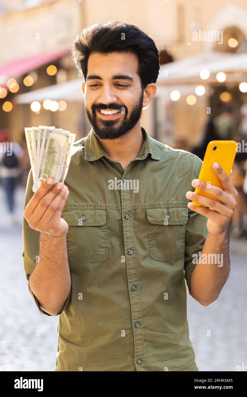Happy rich indian man counting holding money dollar cash, use ...