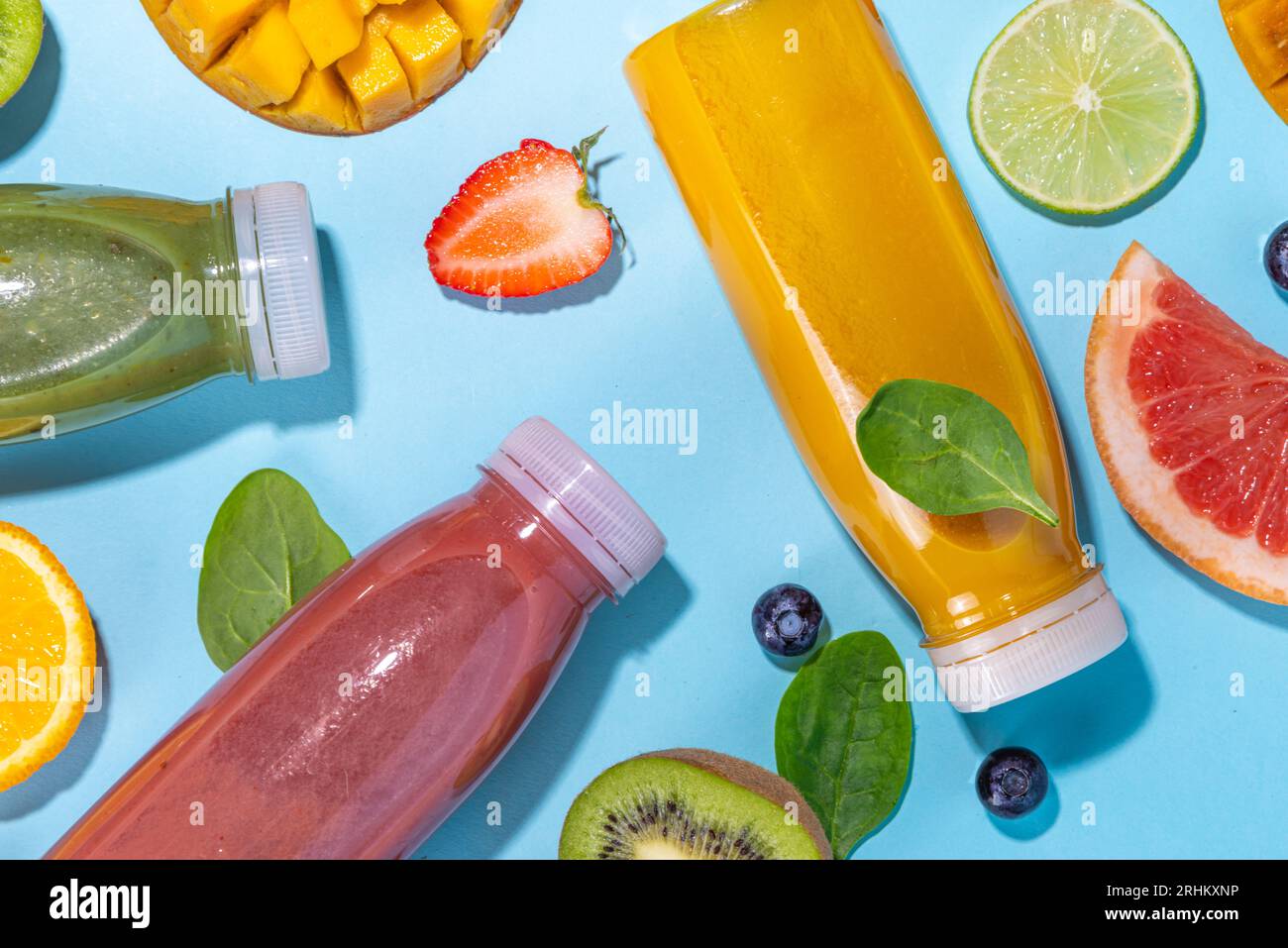 Green, orange and red smoothie in portion bottles, Mix of colourful ...