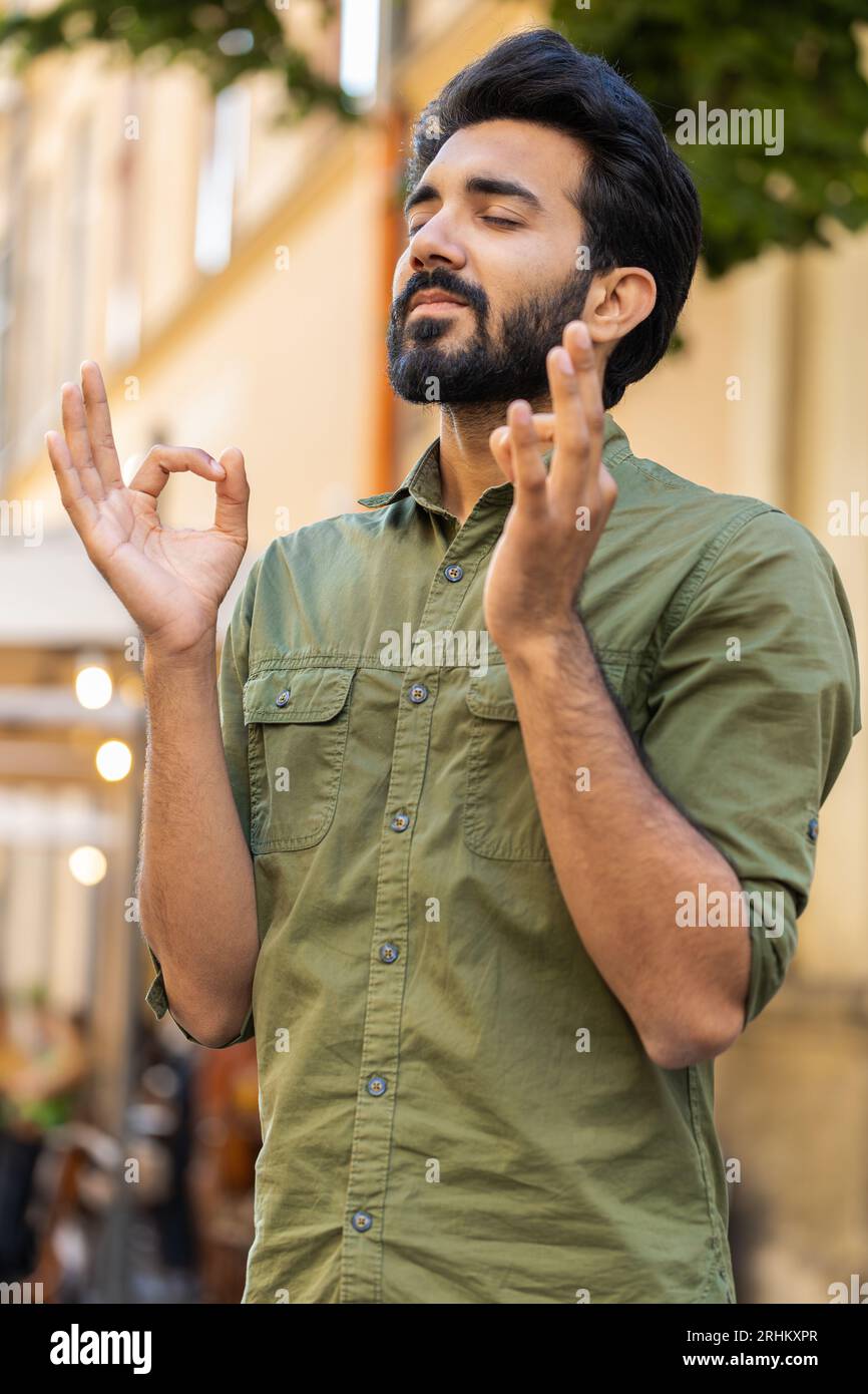 Keep calm down, relax. Indian man praying, breathes deeply with mudra ...