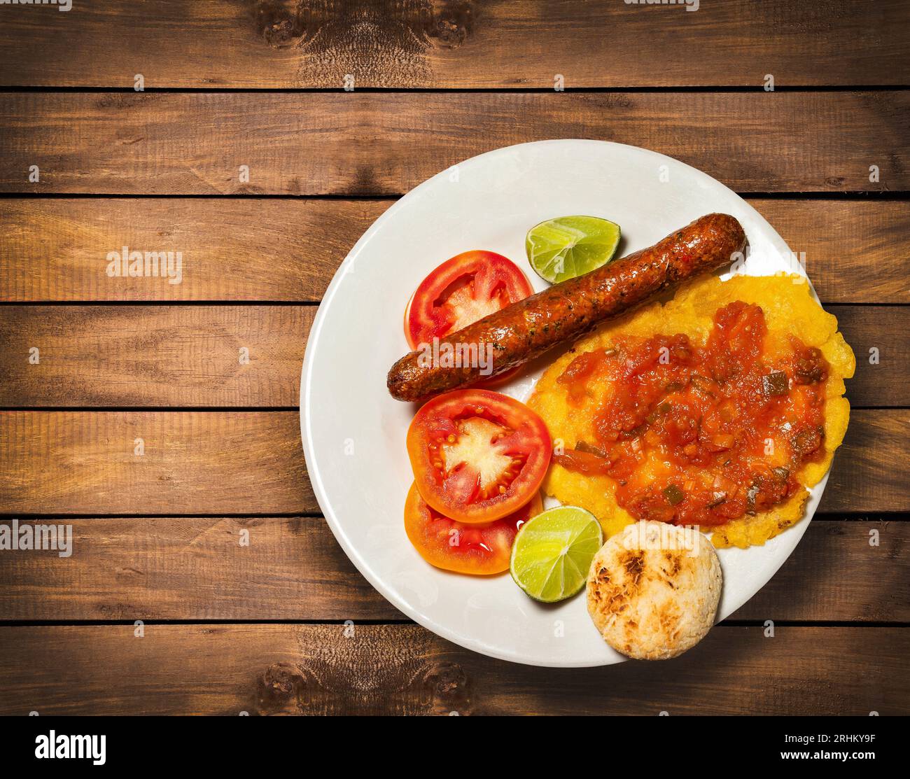 Fried chorizo with patacon and tomatoes - Colombian traditional food ...