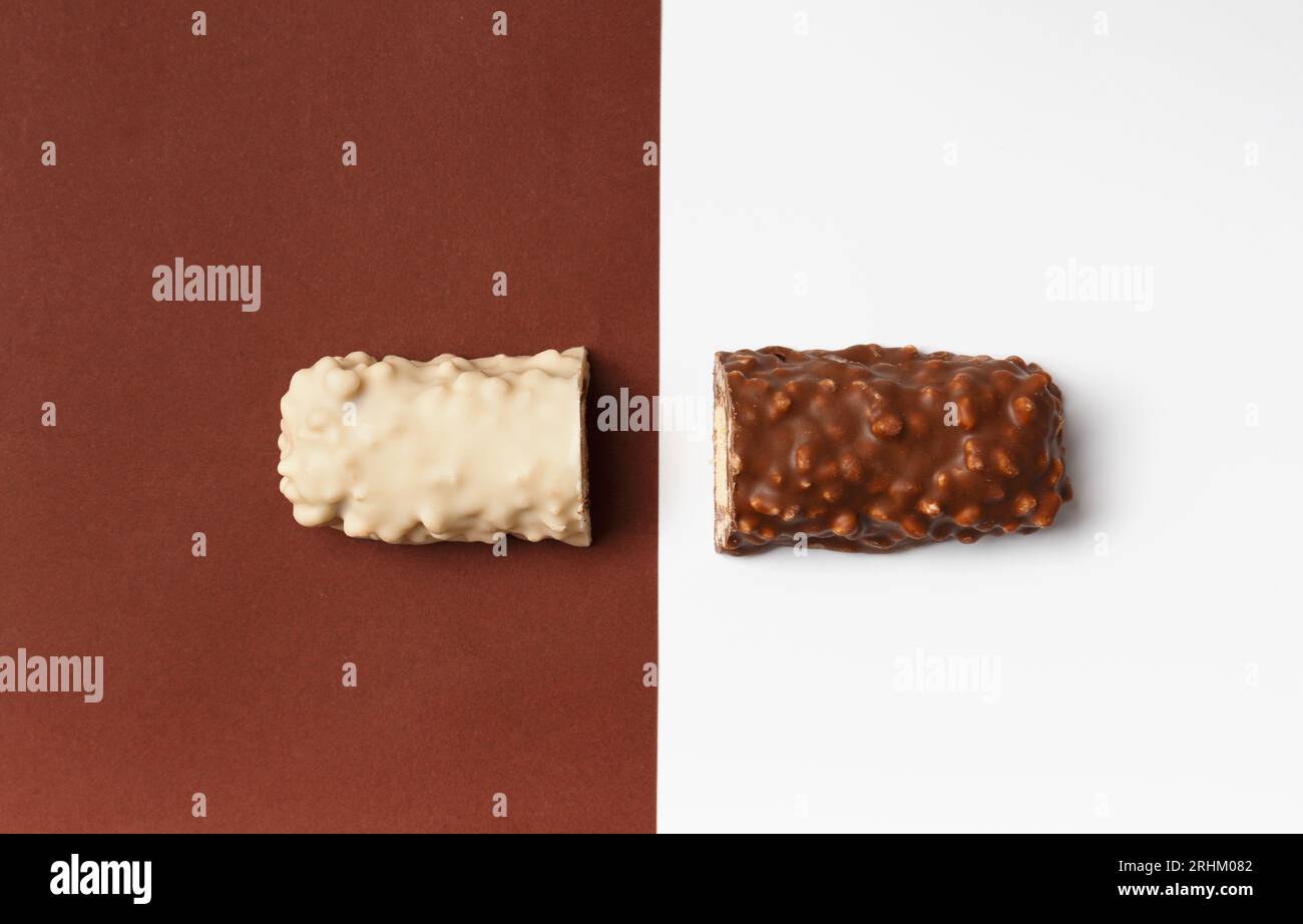 White and dark chocolate on brown and white background, top view ...
