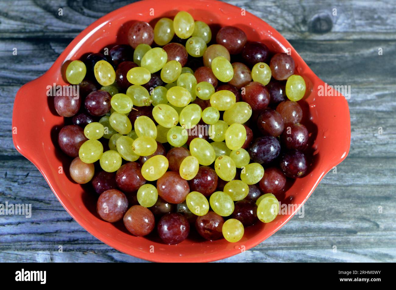 Green and Red fresh grapes, a fruit, botanically a berry of the ...
