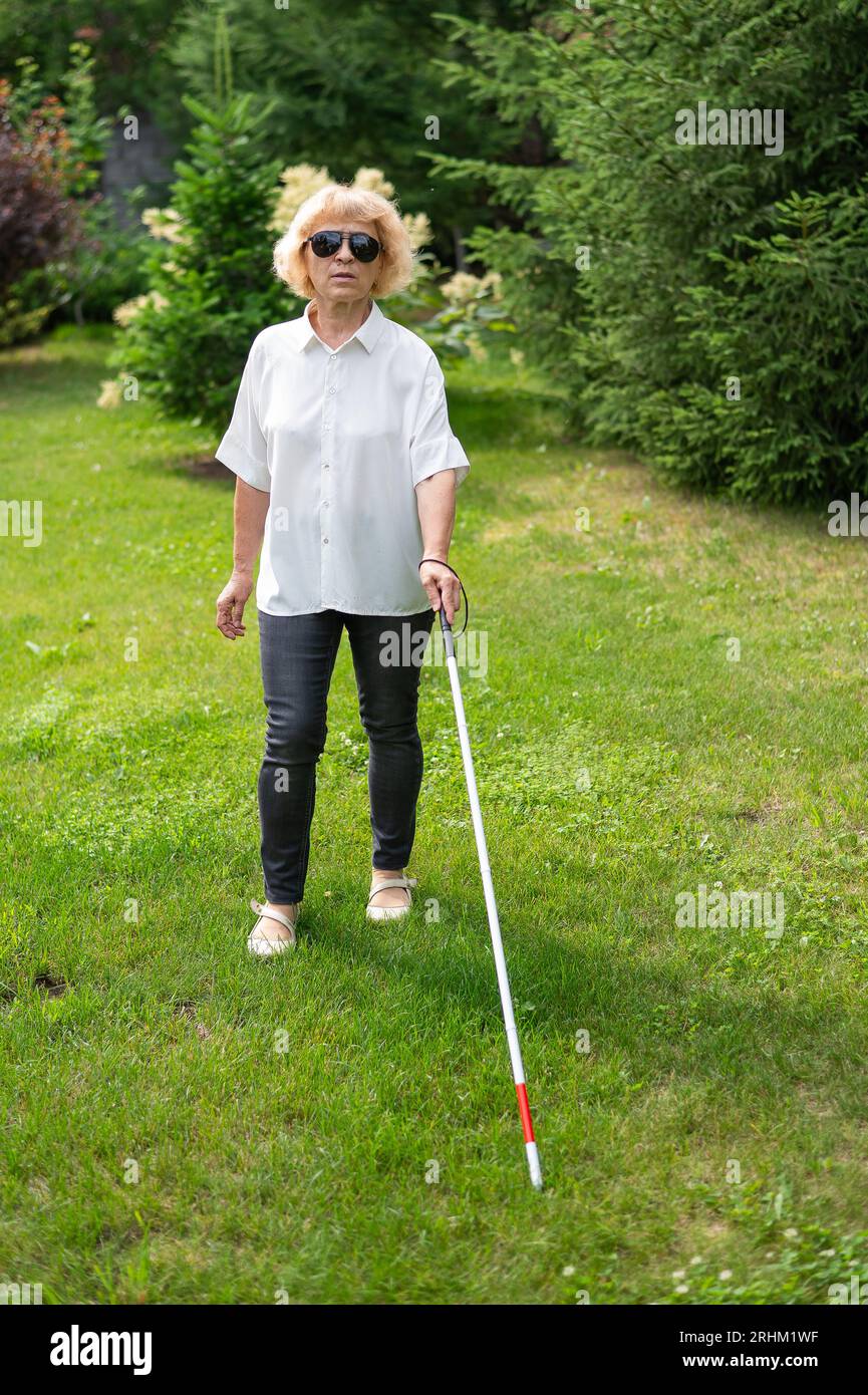 Elderly blind woman walking hi-res stock photography and images - Alamy