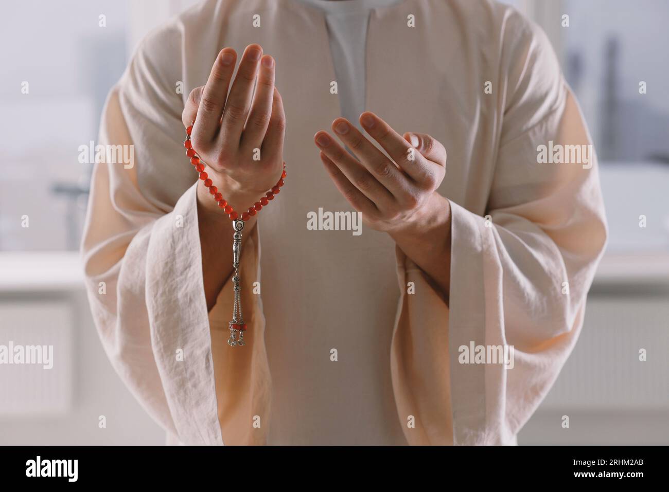 Muslim man with misbaha praying near window indoors, closeup Stock ...
