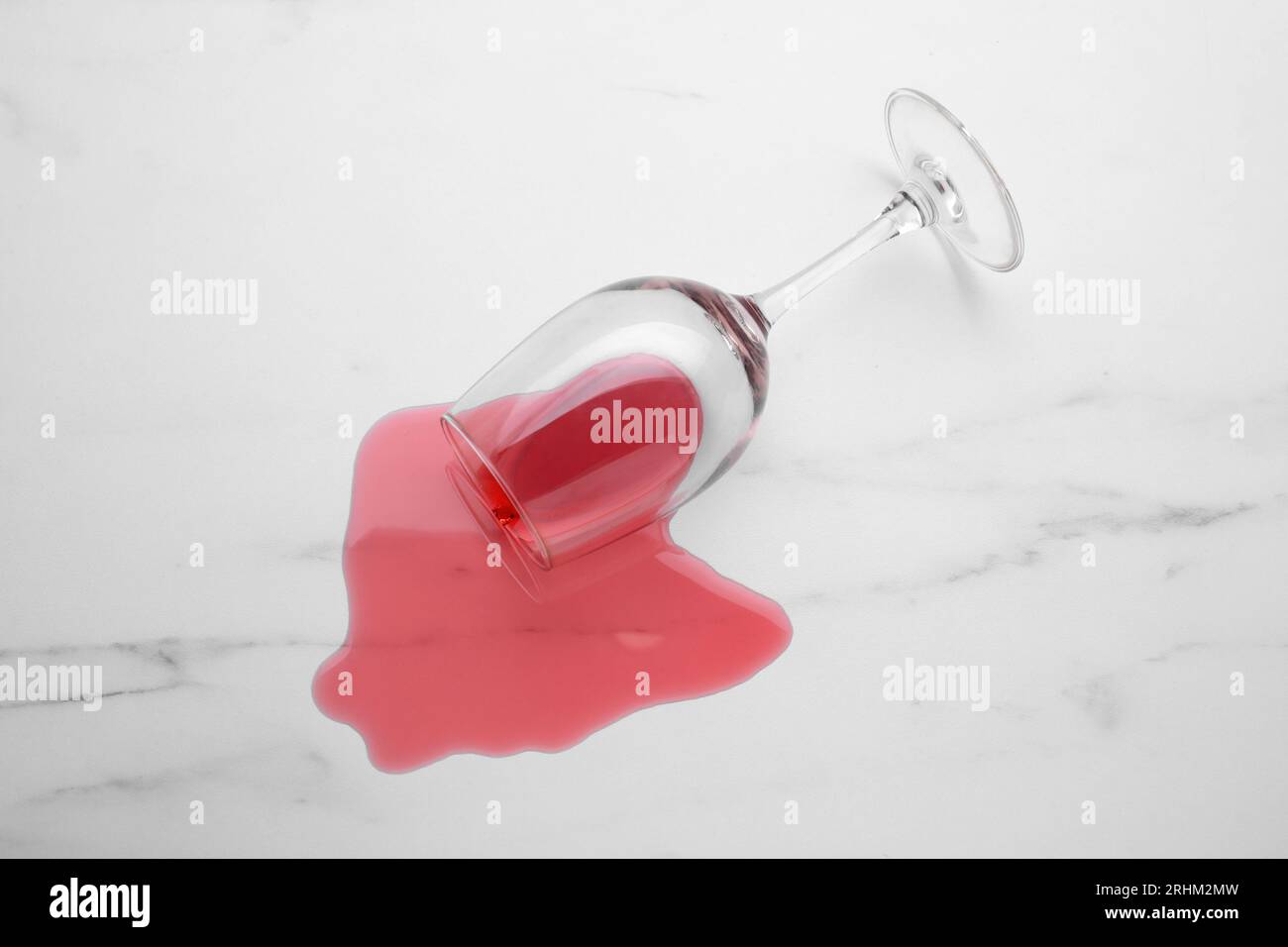 Glass with spilled red wine on white marble surface, top view Stock ...