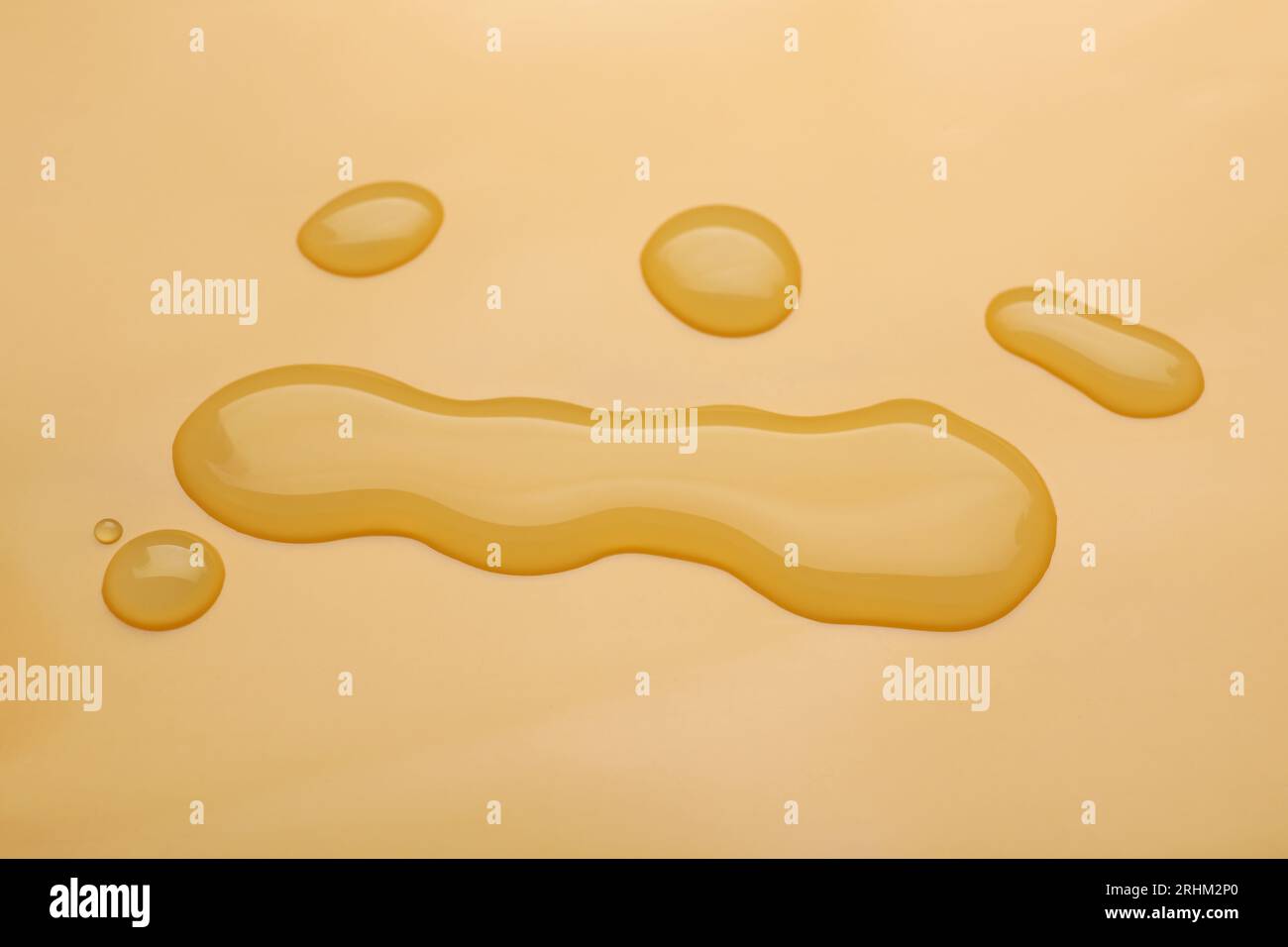Puddle of water on pale orange background Stock Photo - Alamy