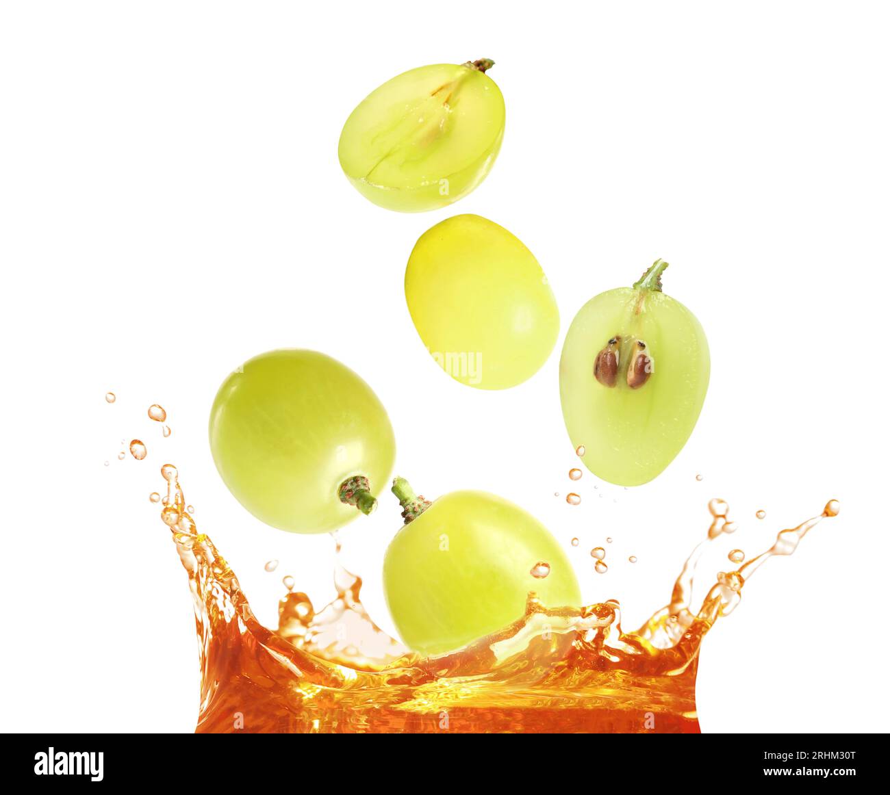 Grapes falling into juice on white background Stock Photo - Alamy