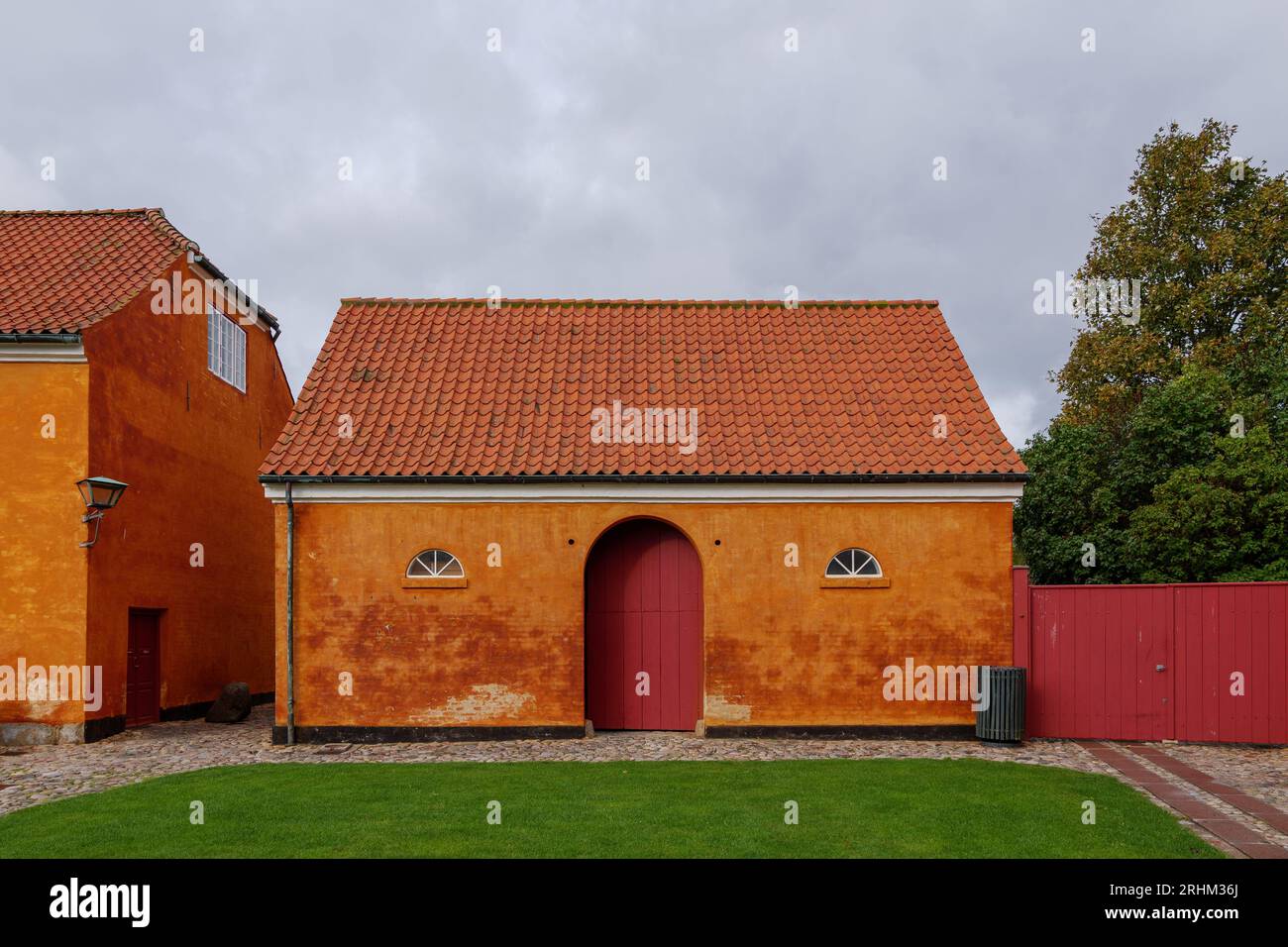 Exterior symmetric front view of old orange stucco wall with single ...