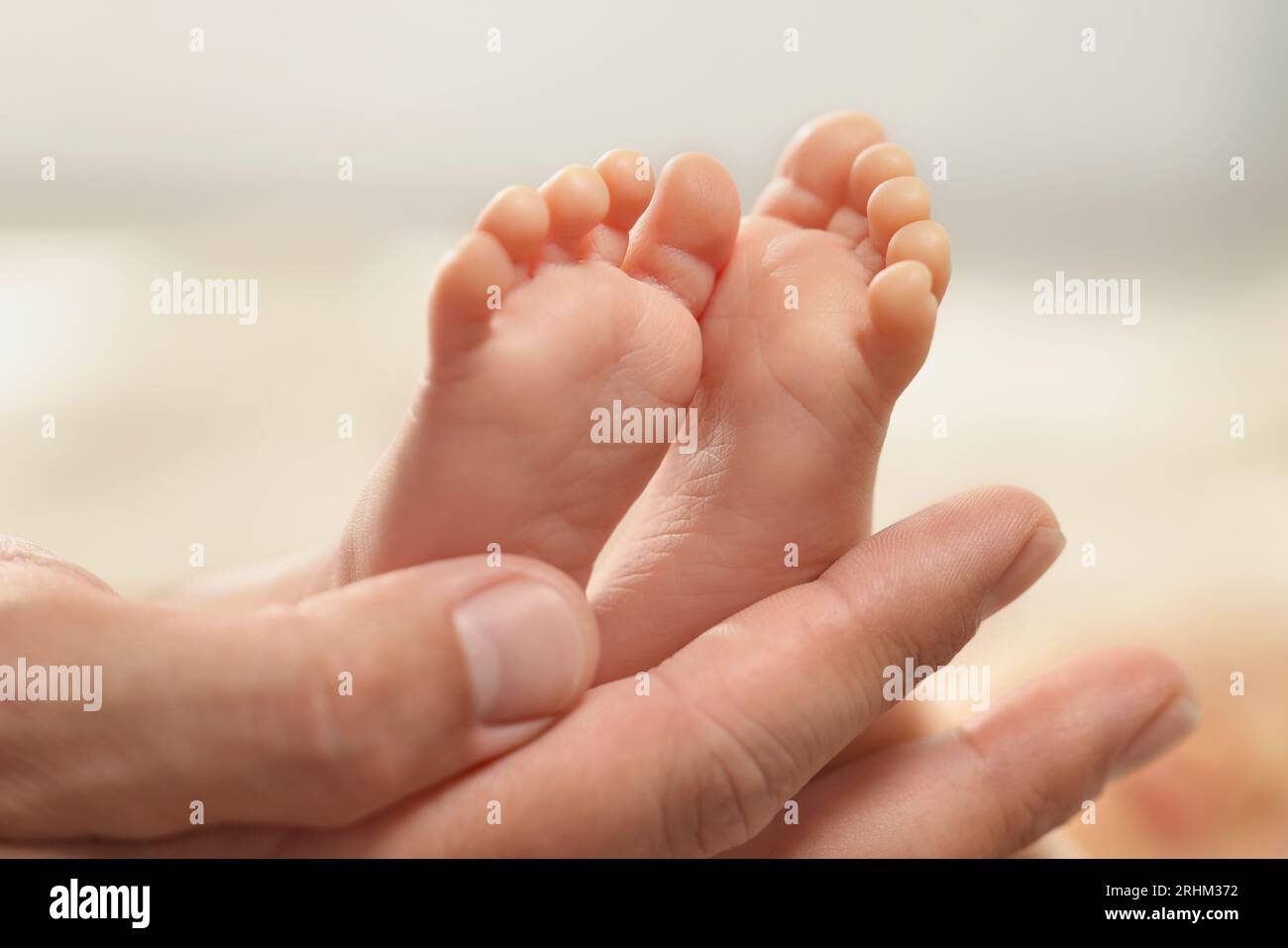 Father holding his newborn baby, closeup view on feet. Lovely family ...