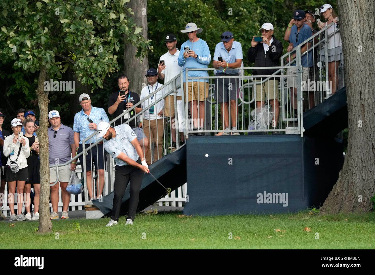 Jon Rahm hits to the 15th green after taking a drop near the ...