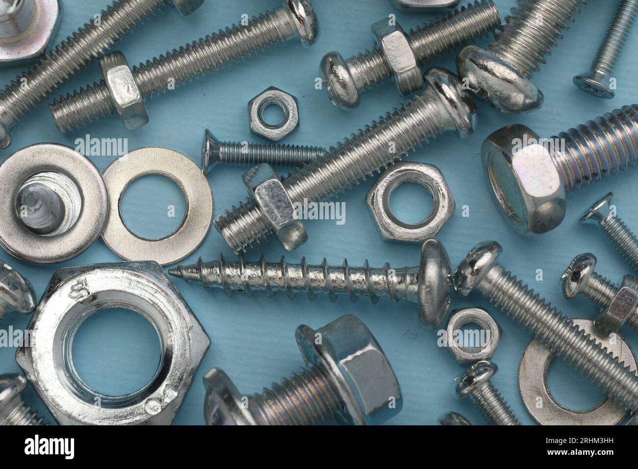 Many different fasteners on light blue background, flat lay Stock Photo ...