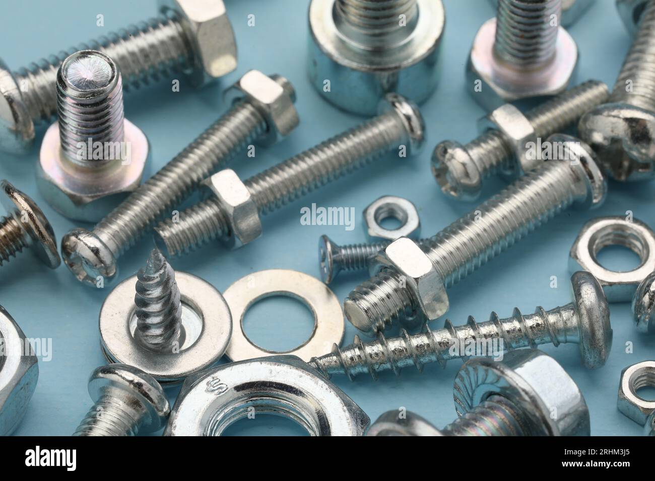 Many different fasteners on light blue background, closeup Stock Photo ...
