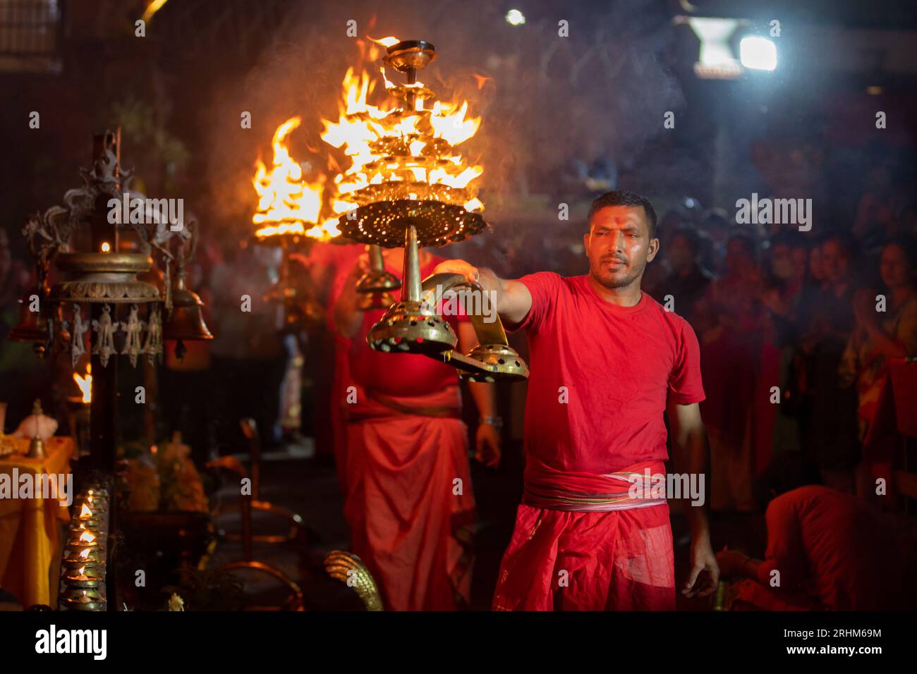 Nepalese priest performing evening arati Stock Photo - Alamy