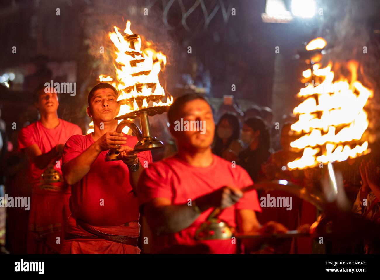 Nepalese priest performing evening arati Stock Photo - Alamy
