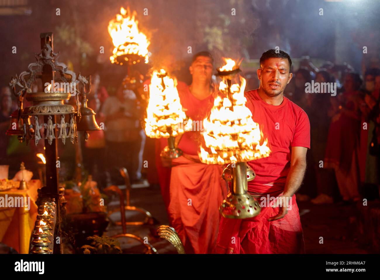 Nepalese priest performing evening arati Stock Photo - Alamy