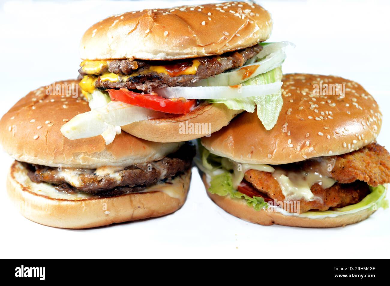 Pile of sesame buns of fried breaded chicken fillet patties, crisp ...