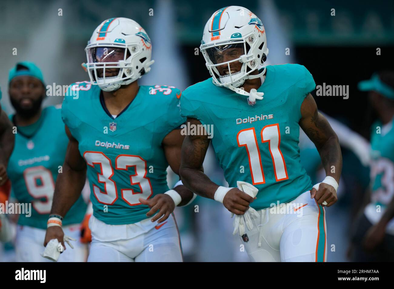 Miami Dolphins running back Chris Brooks (33) and wide receiver Cedrick ...