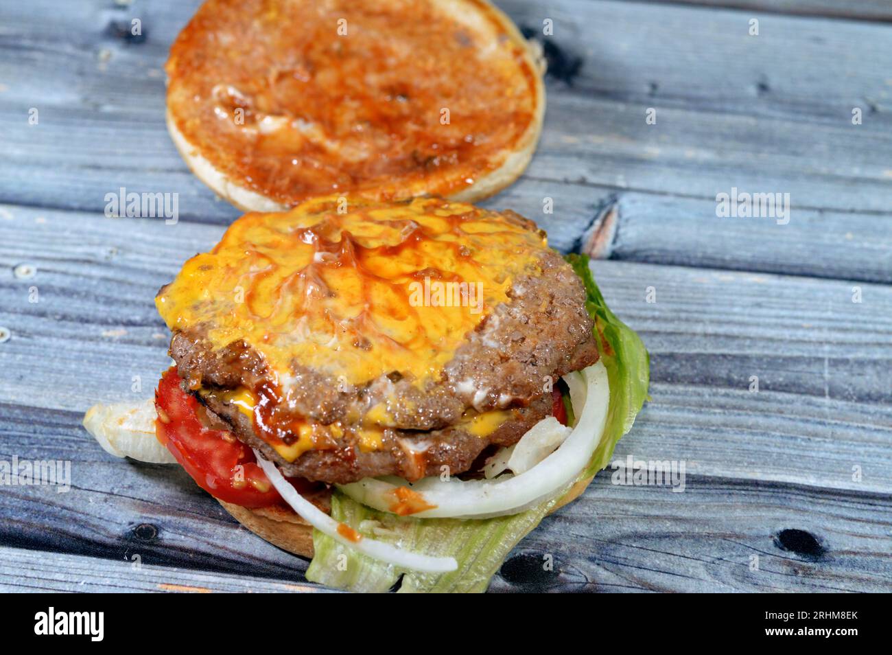 A juicy thick double beef patty with cheese covered with sauce, crispy ...