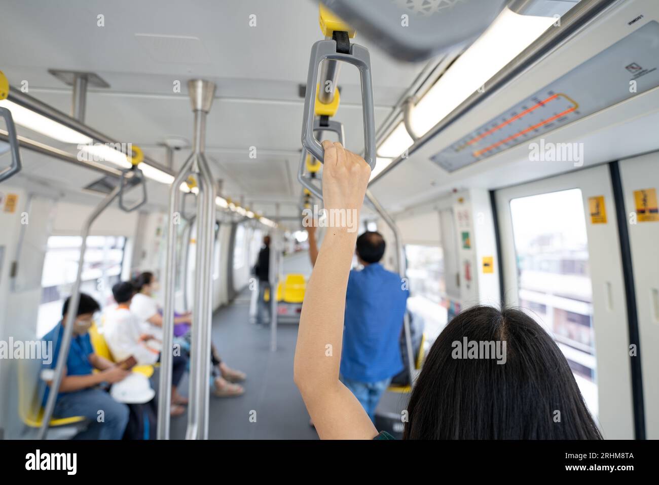 Woman hand firm grip safety handrail in elevated monorail train. Mass ...