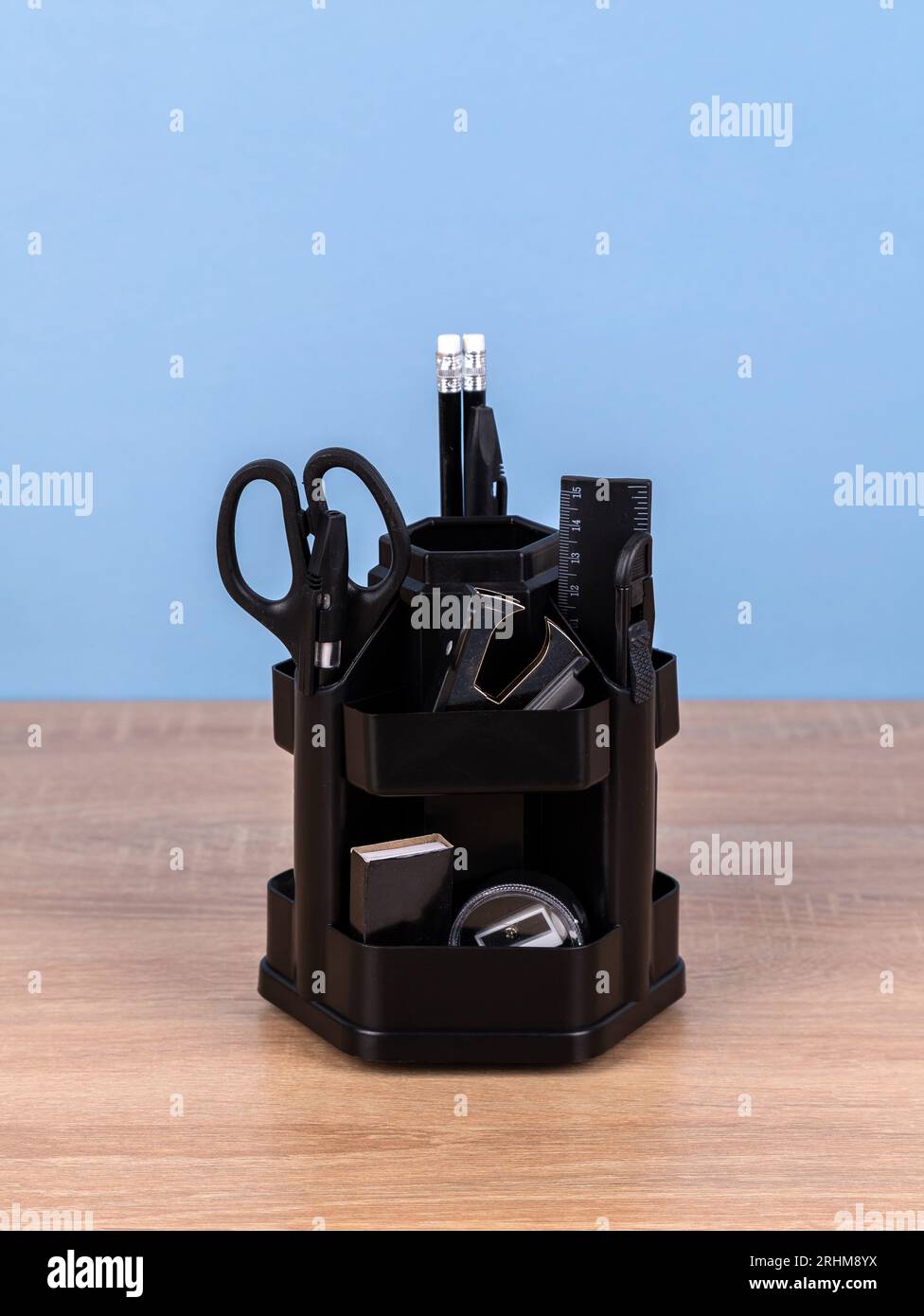 Black desktop organizer with school stationary and office supplies over ...