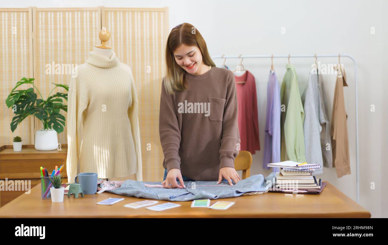 Fashion design concept, Fashion designer measuring size of shirt to ...