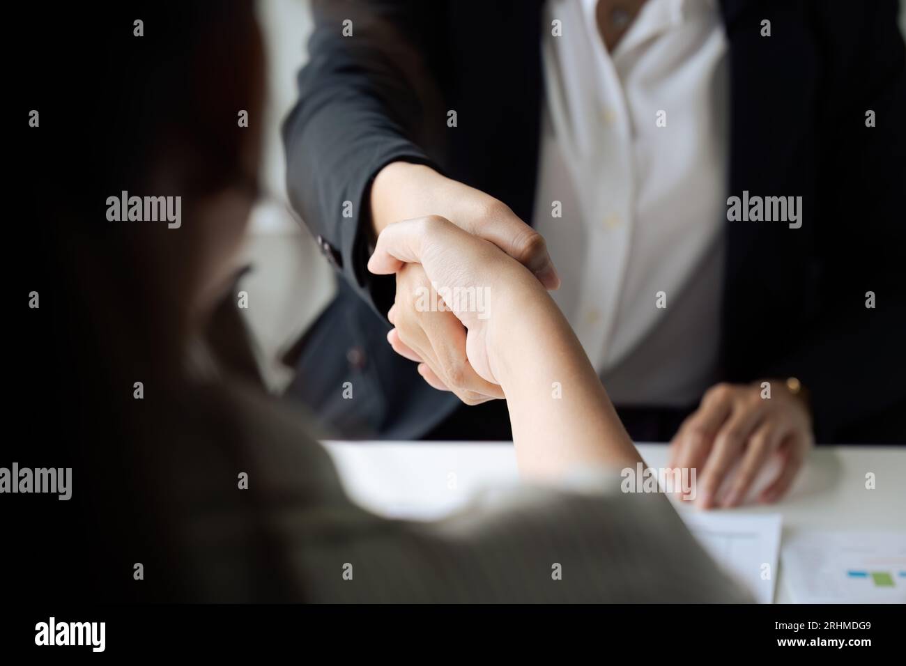 Two professional businesswoman executive leaders shaking hands at ...
