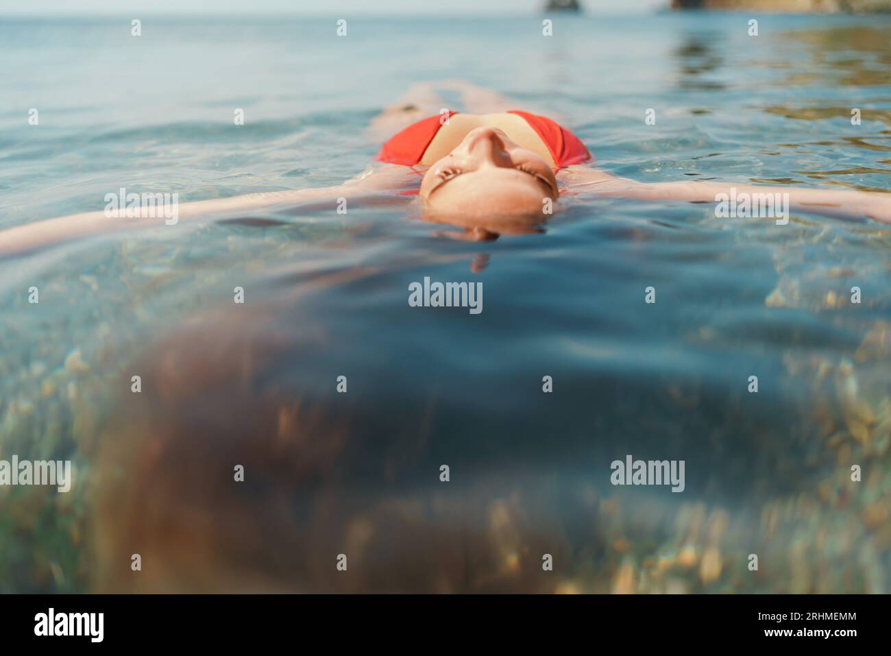 Happy woman sea relaxing floating in transparent sea water on summer ...