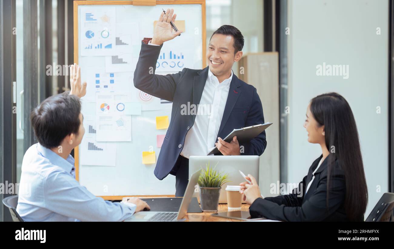 Businesspeople smile and high five , feeling celebrate after project or ...