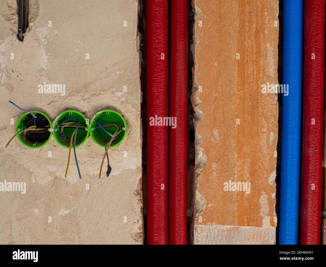 Plastic backbox for sockets or switches inserted into the drilled holes ...