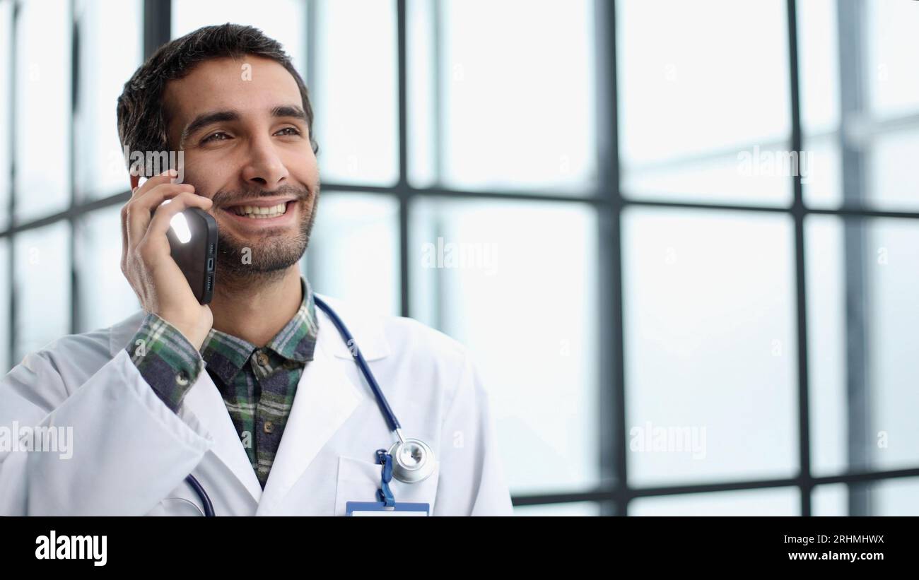 Shot of a male doctor talking on a mobile phone during a hospital Stock ...