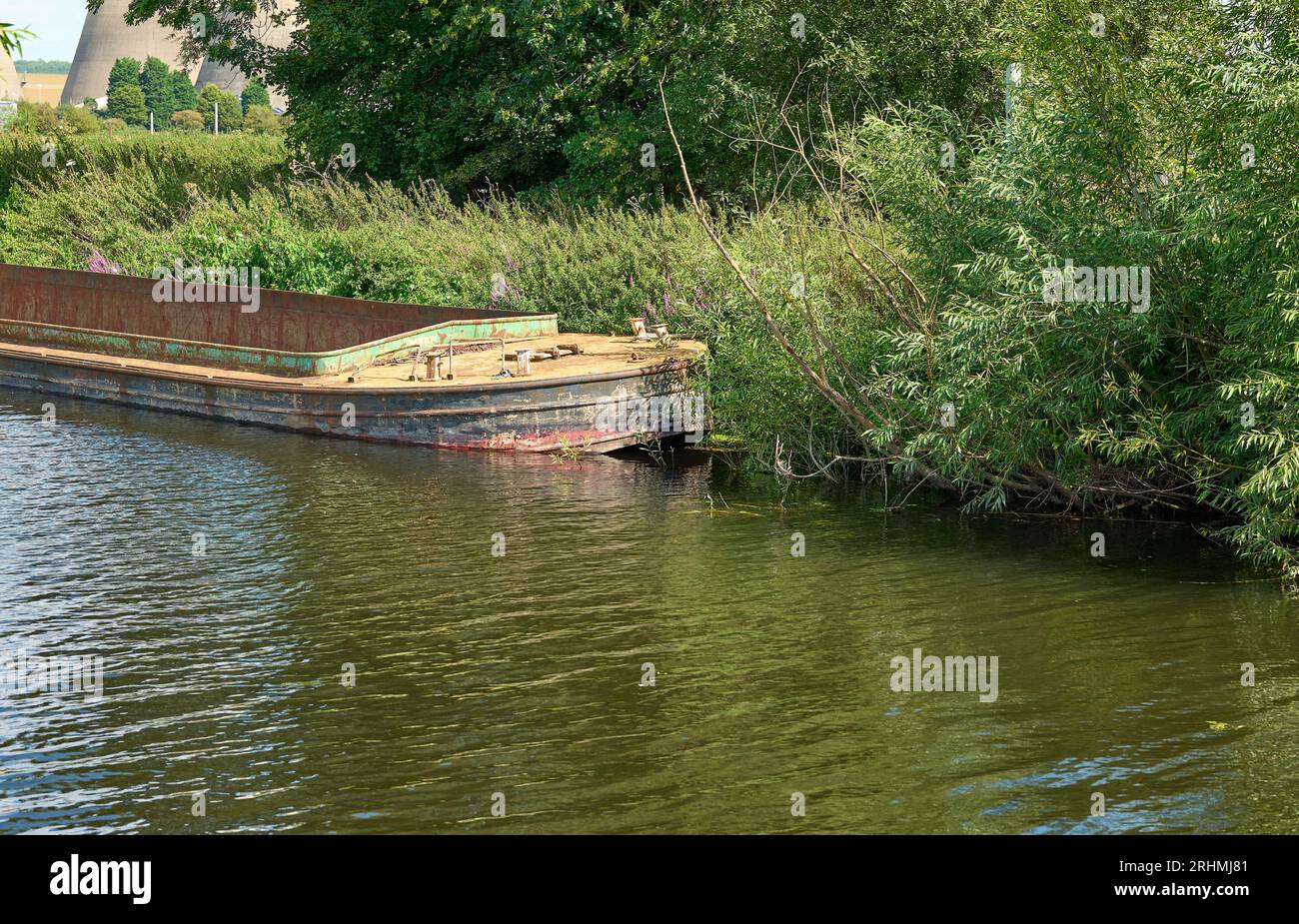 Old abandoned gravel barge moored on a river bank Stock Photo - Alamy