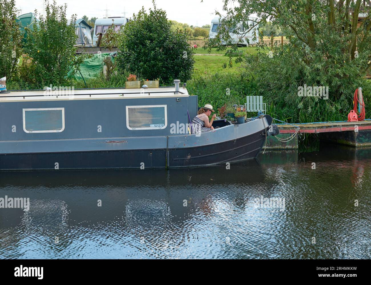 Woman reading book on boat hi-res stock photography and images - Alamy