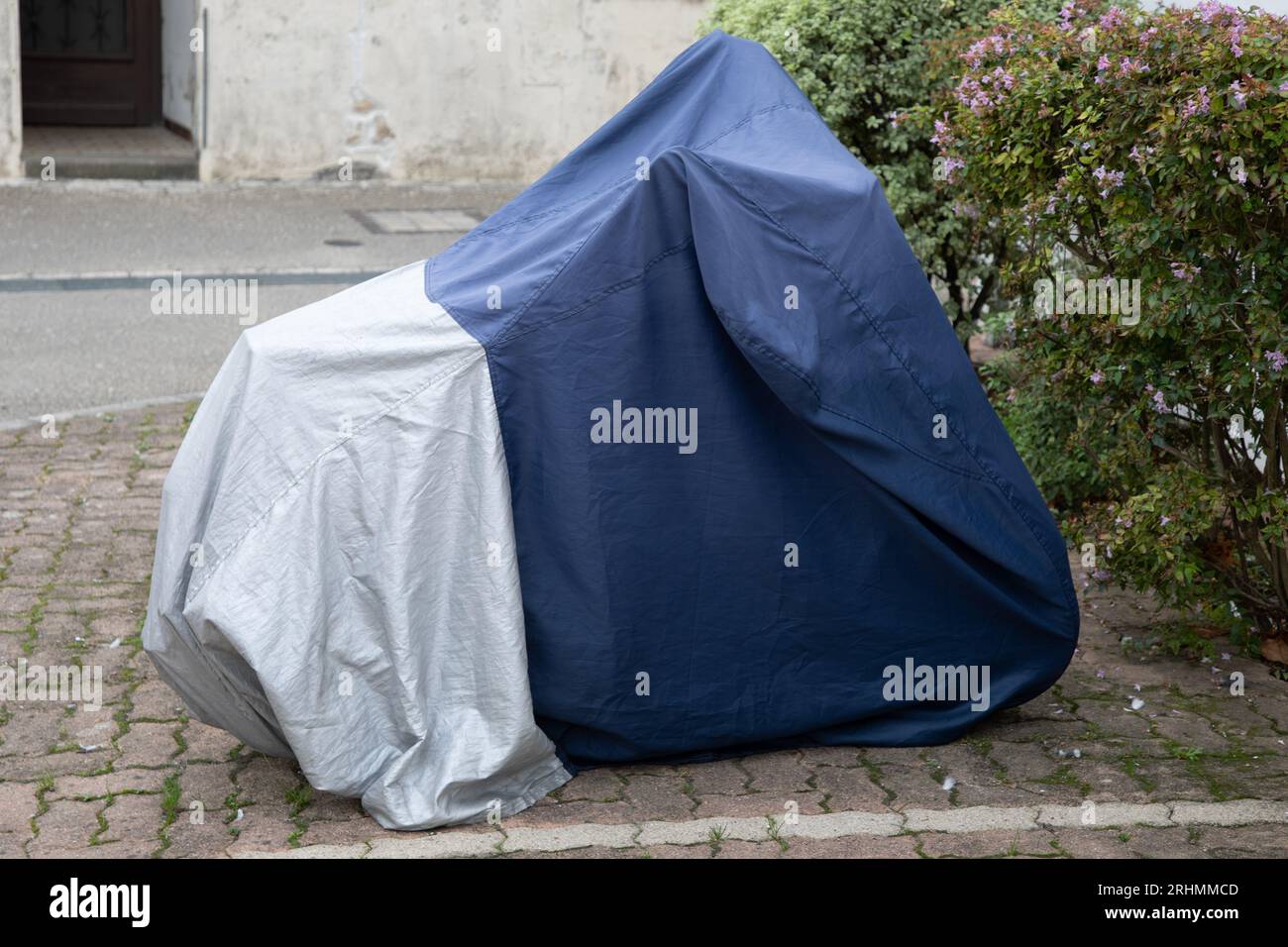 Motorcycle under silver cover hi-res stock photography and images - Alamy