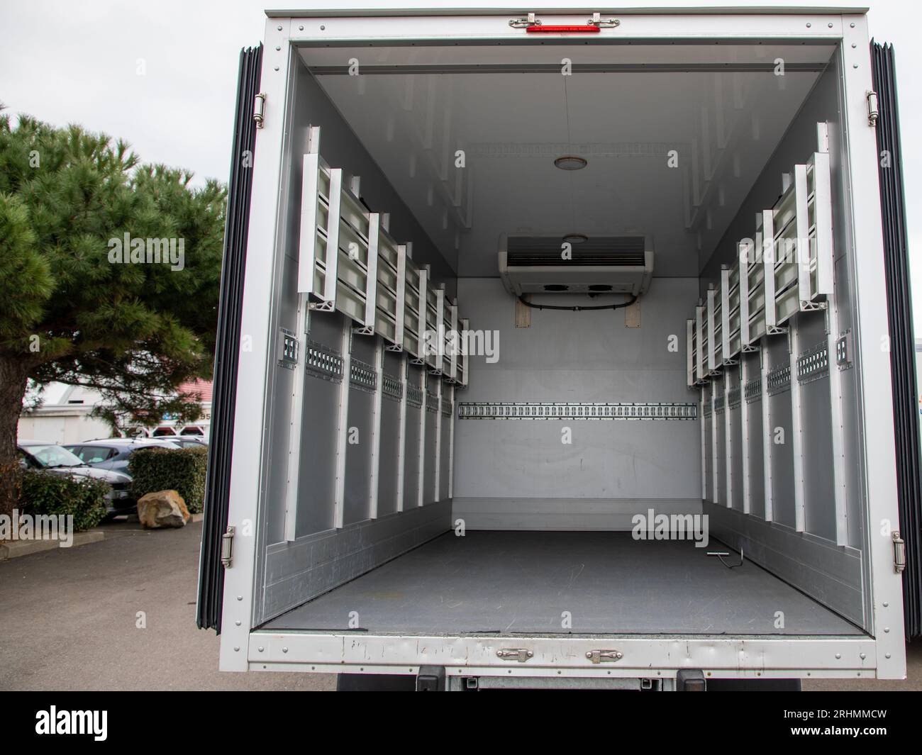 interior van of an empty panel truck with large doors open on empty ...