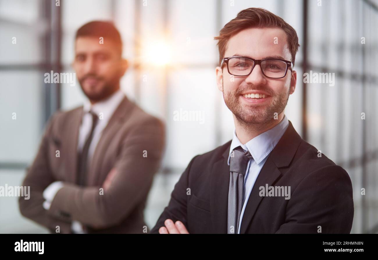Colleagues smiling and posing for the camera before a work meeting ...