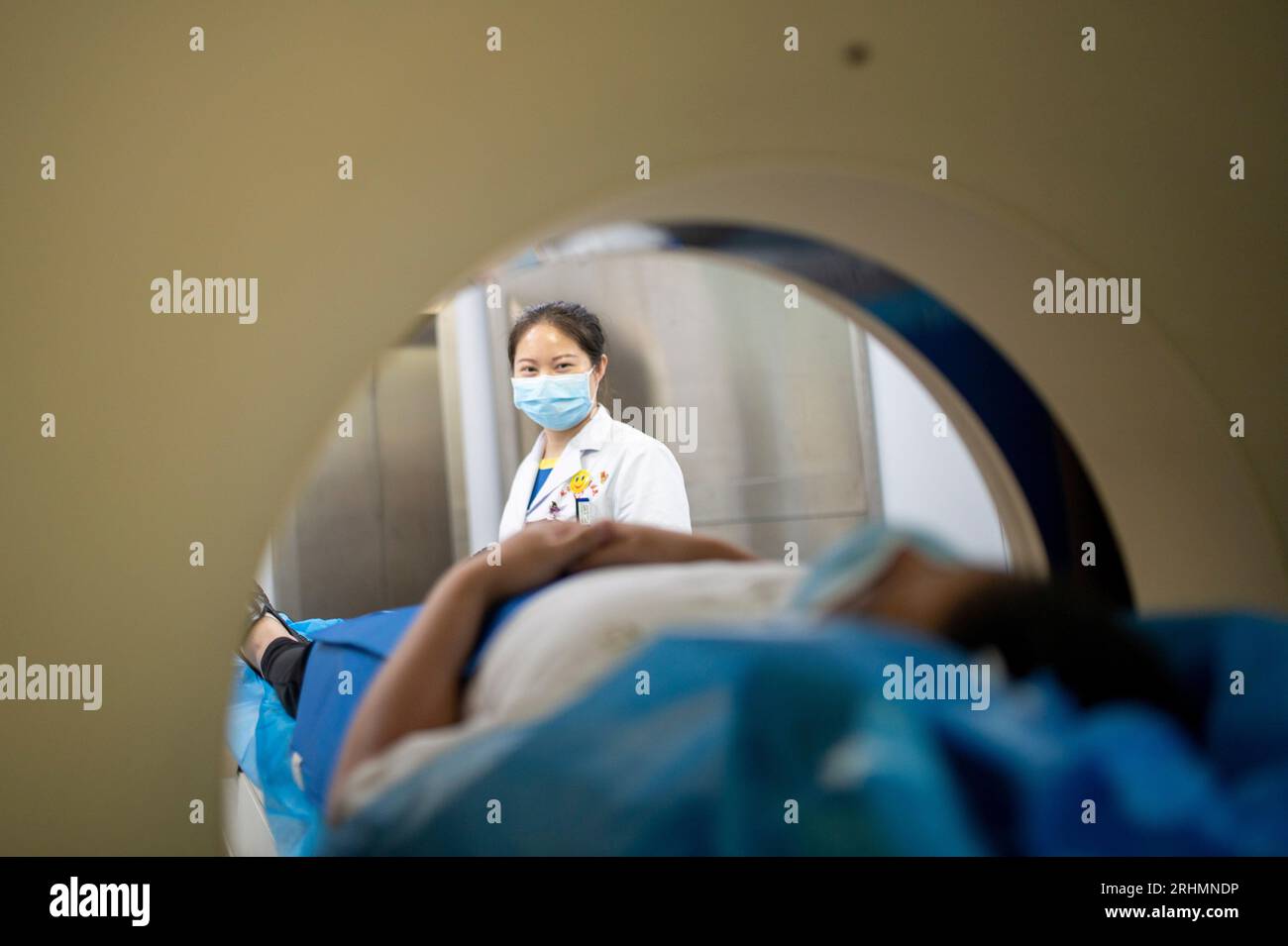 A doctor performs a CT examination on a patient in Qiandongnan, Guizhou ...