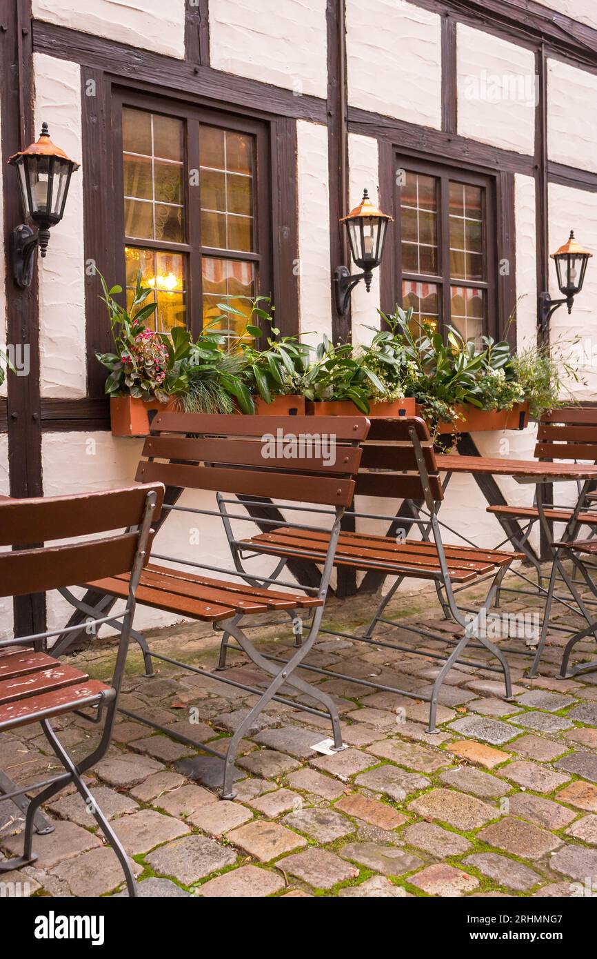 Sidewalk cafe decoration. Outdoor cafe in old town in Germany. Flower ...