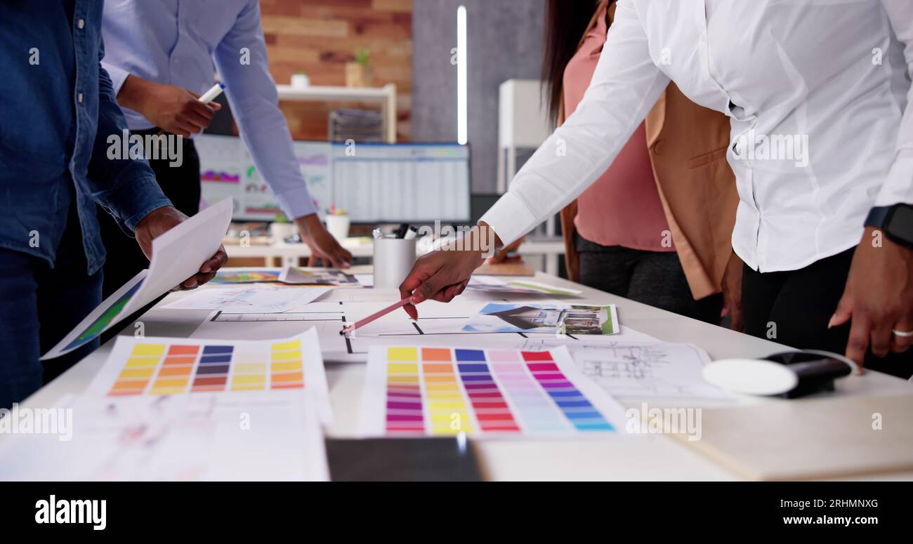 Designer Group At Desk Discussing Custom House Remodel Stock Photo - Alamy