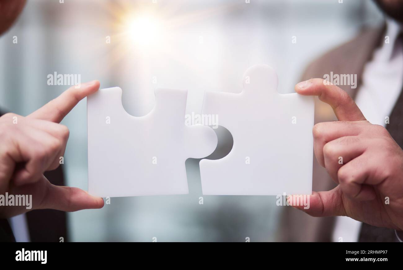 Working together to put things together. two unrecognizable ...