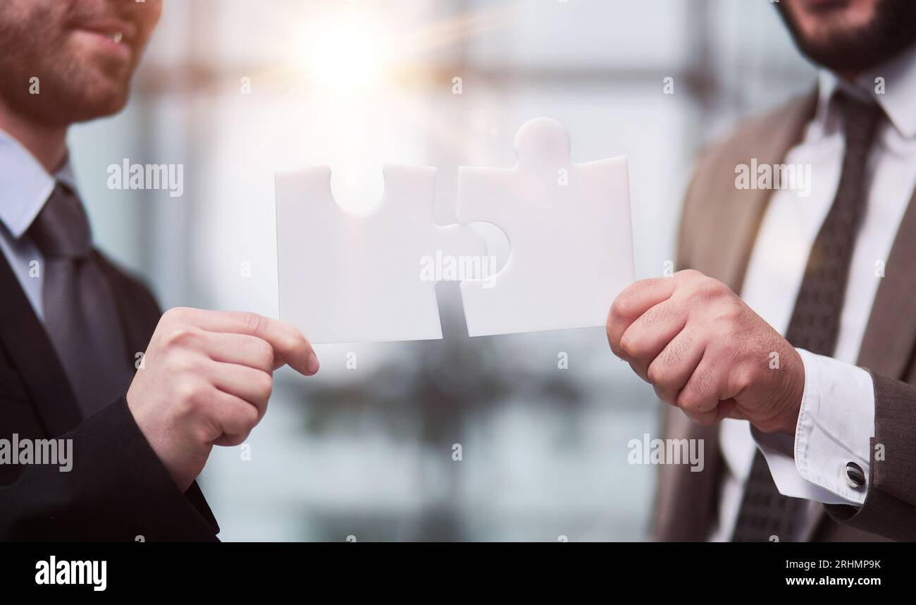 Working together to put things together. two unrecognizable ...