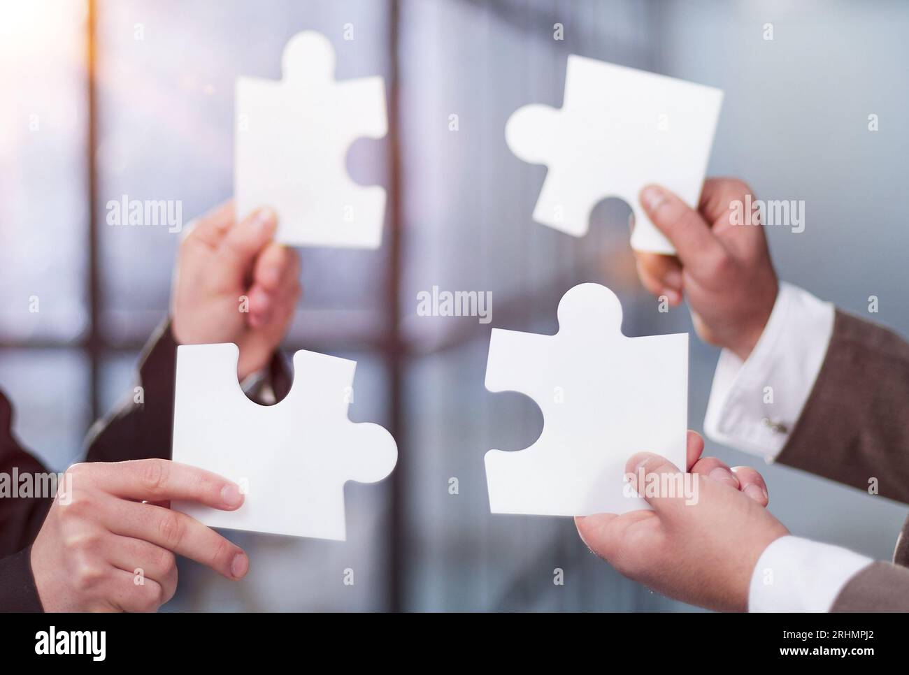 Working together to put things together. two unrecognizable ...